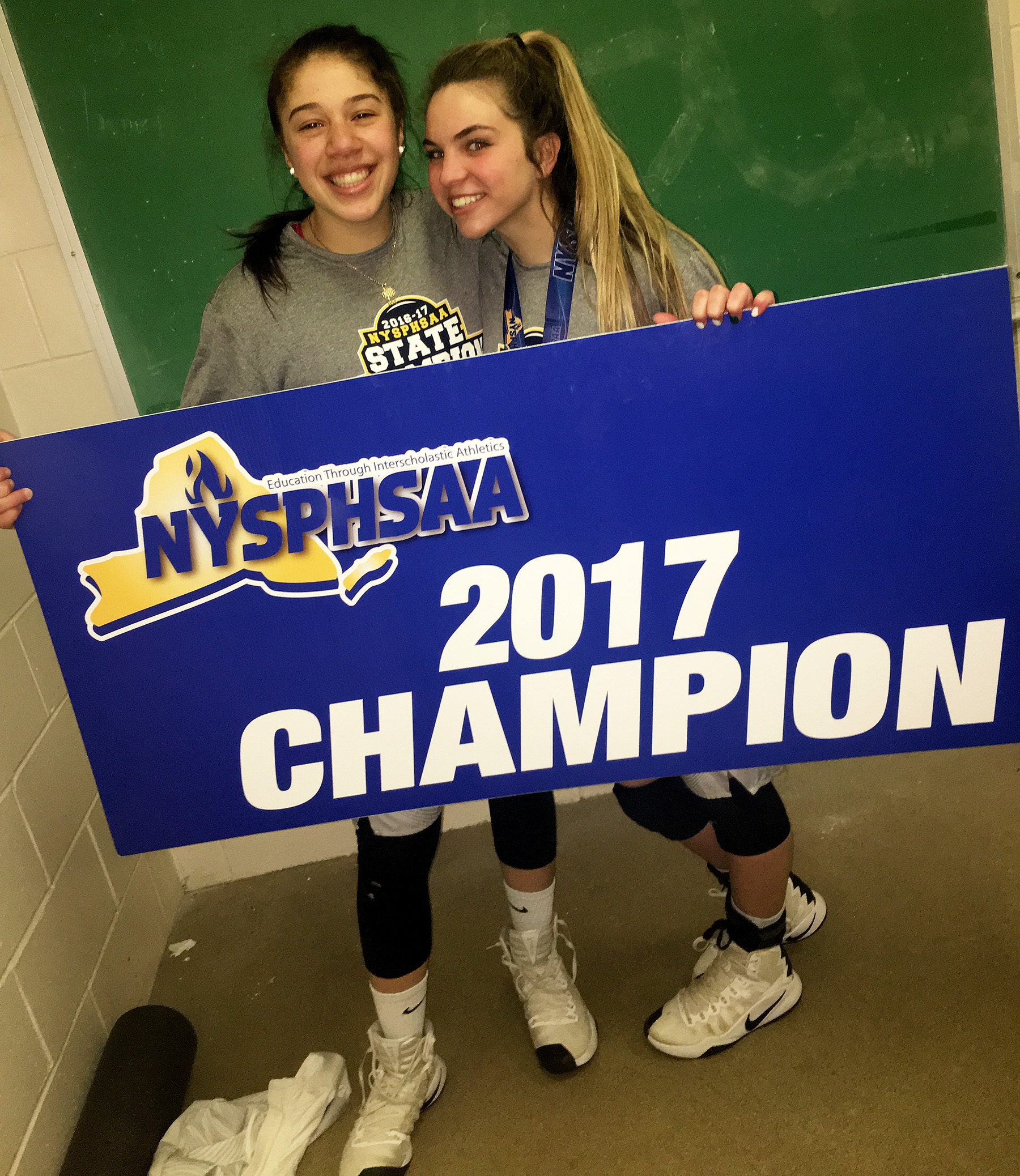 Lexi-and-Hanna-hold-banner | The Catholic Sun